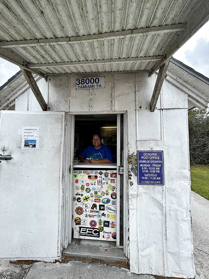 Stickers from visitors worldwide decorate the door, turning it into a colorful guestbook of postal pilgrims.
