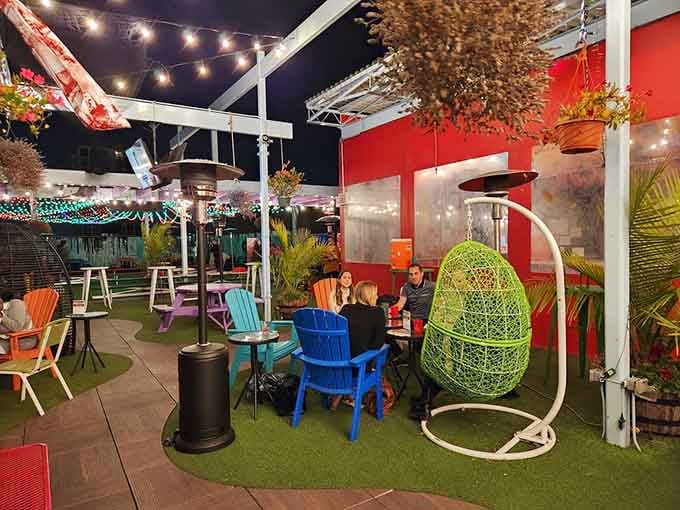 Evening lights transform the rooftop into something magical, where hanging egg chairs and Adirondacks invite serious lounging time ahead.