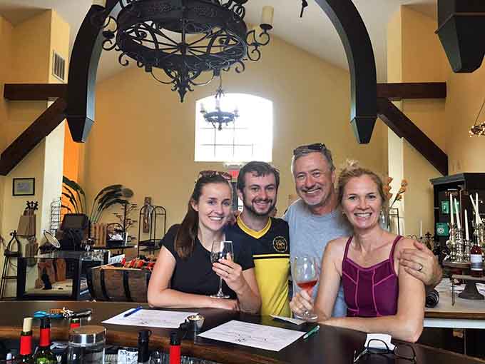 Happy visitors enjoying wine together proves this place brings out smiles faster than a puppy video on Facebook.