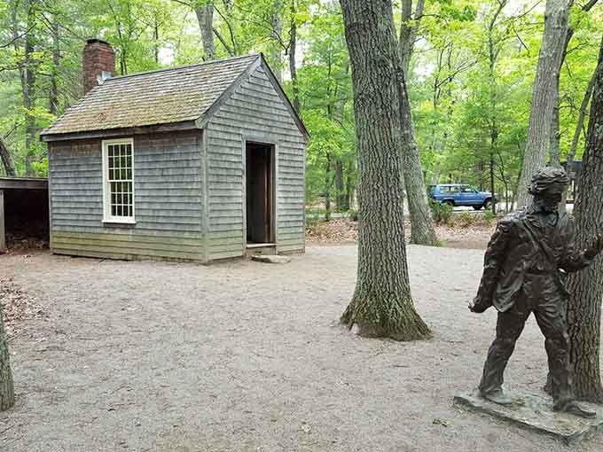 The replica cabin and Thoreau statue offer perspective on minimalist living that makes tiny houses look luxurious.