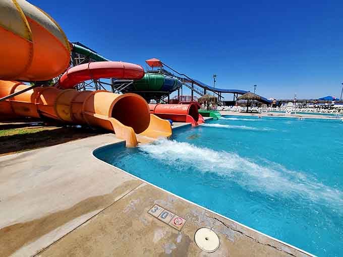 Orange slides spitting out happy customers into turquoise pools, creating splash landings worthy of Olympic judges.