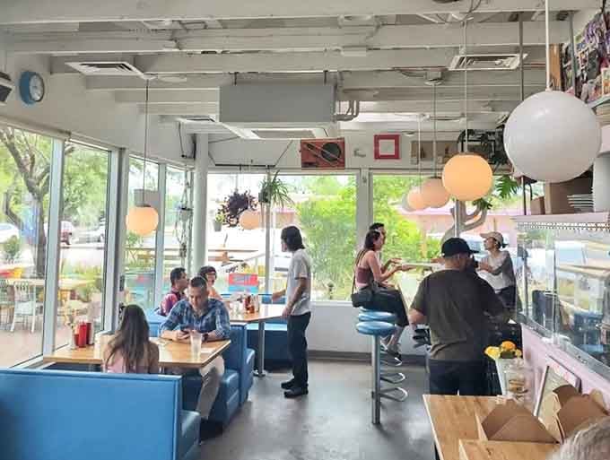 Happy diners in a sun-filled space prove that good food and good vibes create the perfect combination.
