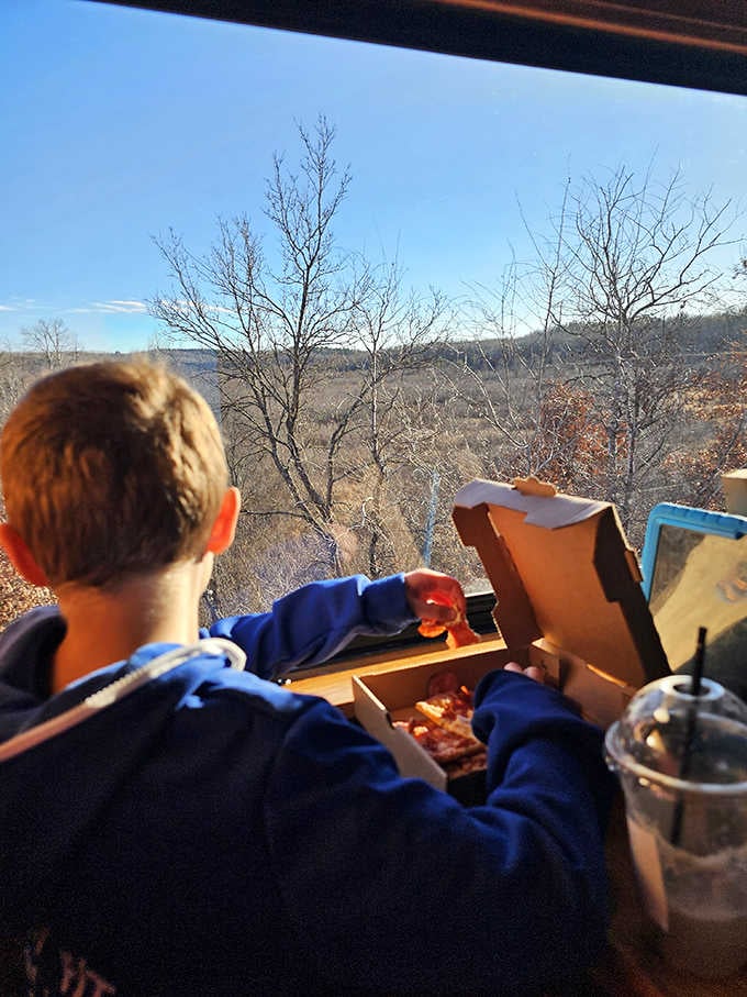 Young passengers discover that pizza tastes exponentially better when consumed while watching Wisconsin scenery roll past your window.