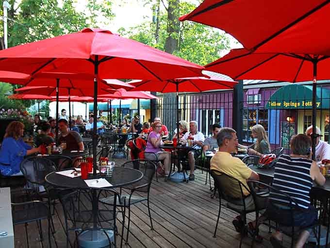 Sunny days bring crowds to the patio, where red umbrellas shade happy diners enjoying Yellow Springs' vibrant village atmosphere.