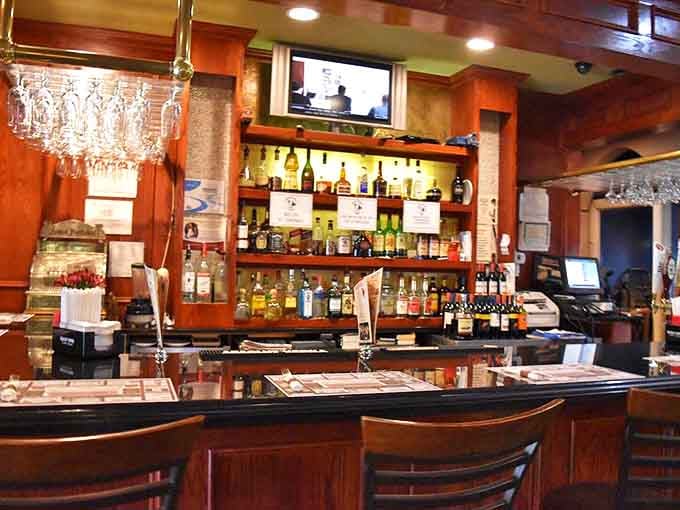 The bar area gleams with bottles and draft taps, ready to pour your beverage of choice in classic style.
