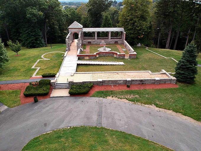 Stone ruins rise majestically from manicured grounds, blending history with horticultural artistry beautifully.