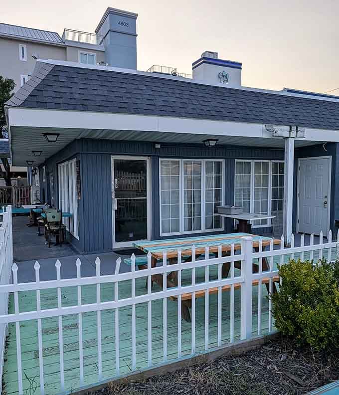 That dark blue cottage-style building at dusk looks like the perfect ending to a perfect beach day.