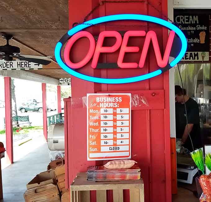 That neon OPEN sign is like a lighthouse for hungry souls, guiding them to salvation six days a week.