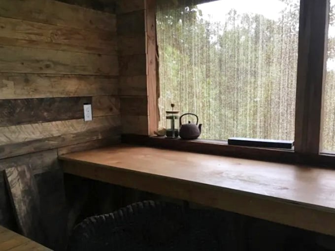 The kitchen window overlooks nature's own entertainment system, better than any television could ever hope to be.