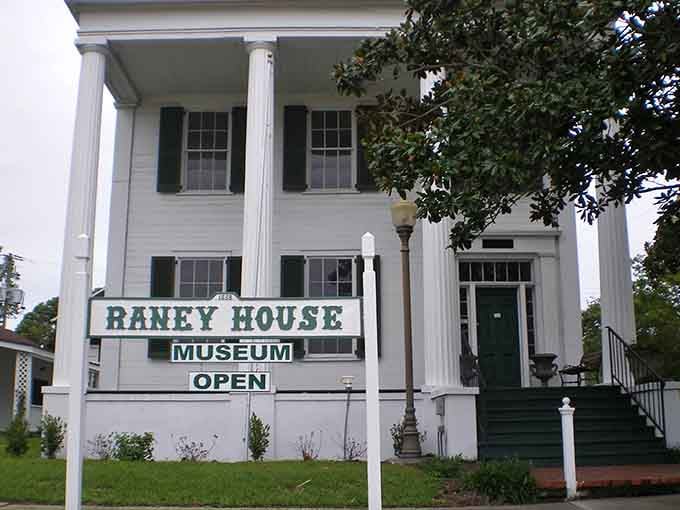 Classic columns frame a museum preserving stories from when this waterfront town shaped regional history.