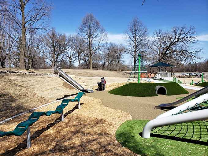 Modern playground equipment sprawls across the landscape like a colorful obstacle course designed by someone who understands kids.