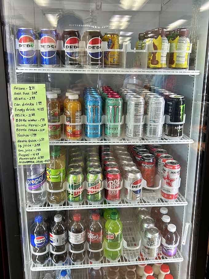 A beverage cooler stocked with everything from Pepsi to energy drinks, because hydration matters even during sugar binges.