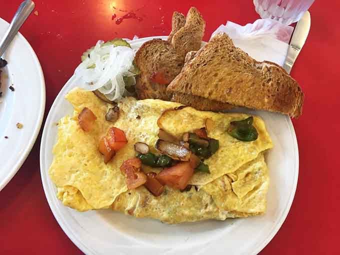 That omelet stuffed with vegetables and served with toast is breakfast taking itself very seriously indeed.
