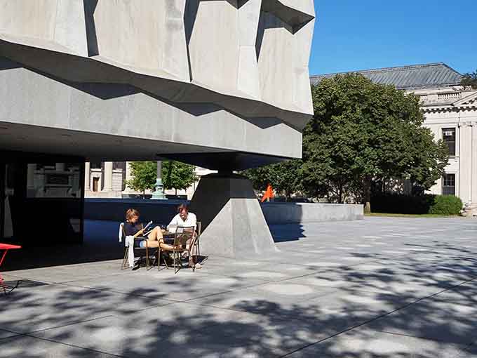 Visitors enjoying the plaza outside, probably discussing whether they've ever seen anything quite this architecturally stunning before in Connecticut.