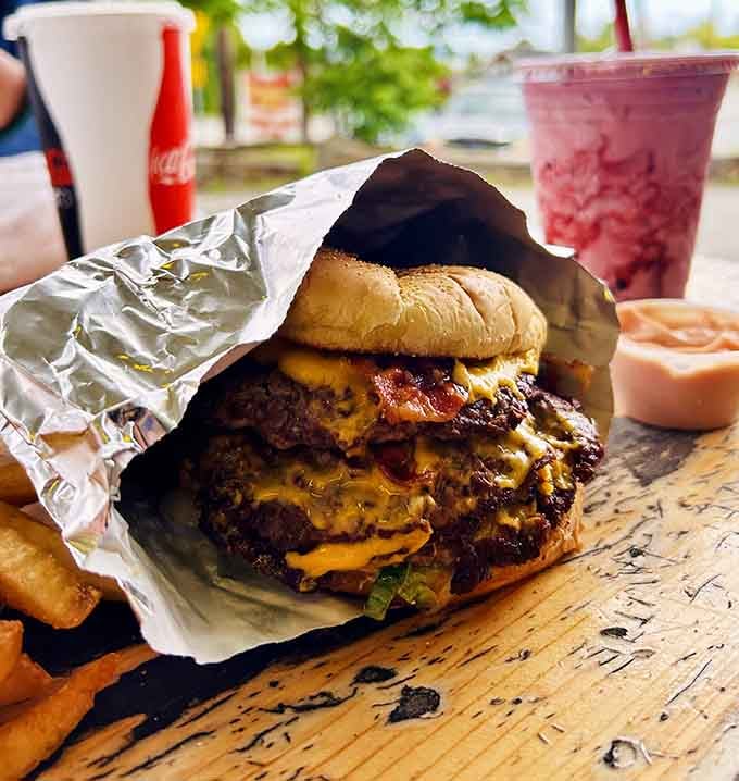 Bacon and cheese team up for the ultimate power couple, draped over a juicy patty that's cooked to perfection.