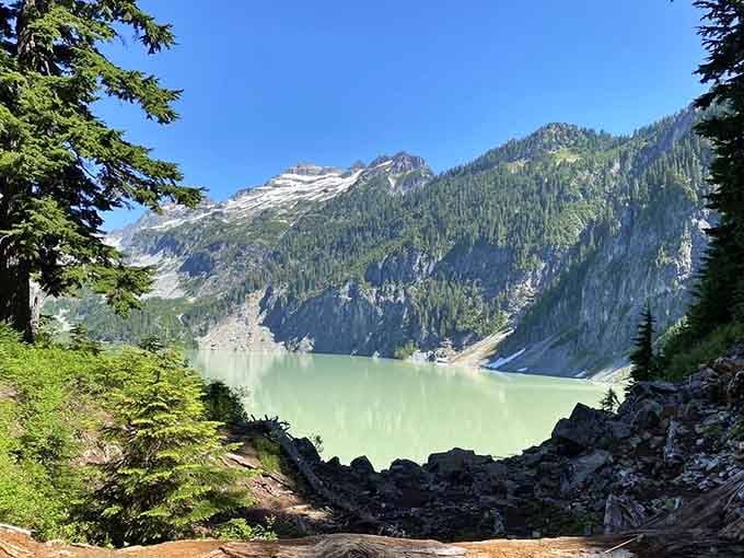 The descent reveals new perspectives of the lake, each viewpoint more breathtaking than the last discovery.