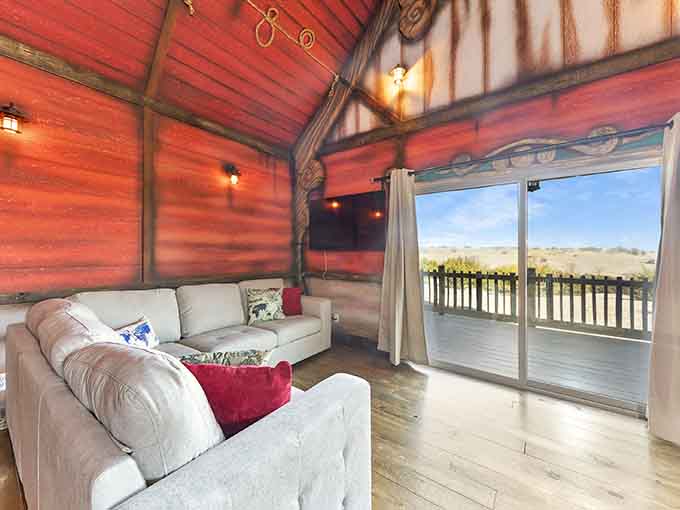 Vaulted wood ceilings and plush sectionals create a cozy retreat that somehow feels both rustic and refined, like country living grew up.