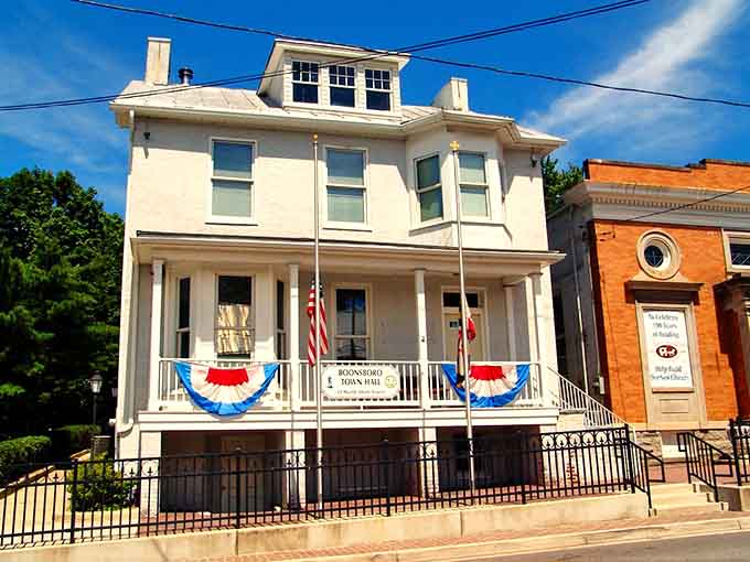 Patriotic bunting adorns this elegant white building that serves as the heart of civic life, where community decisions happen and neighbors become friends.
