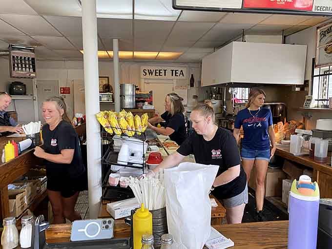 A team moving with the practiced rhythm of people who've made thousands of hot dogs and still care.