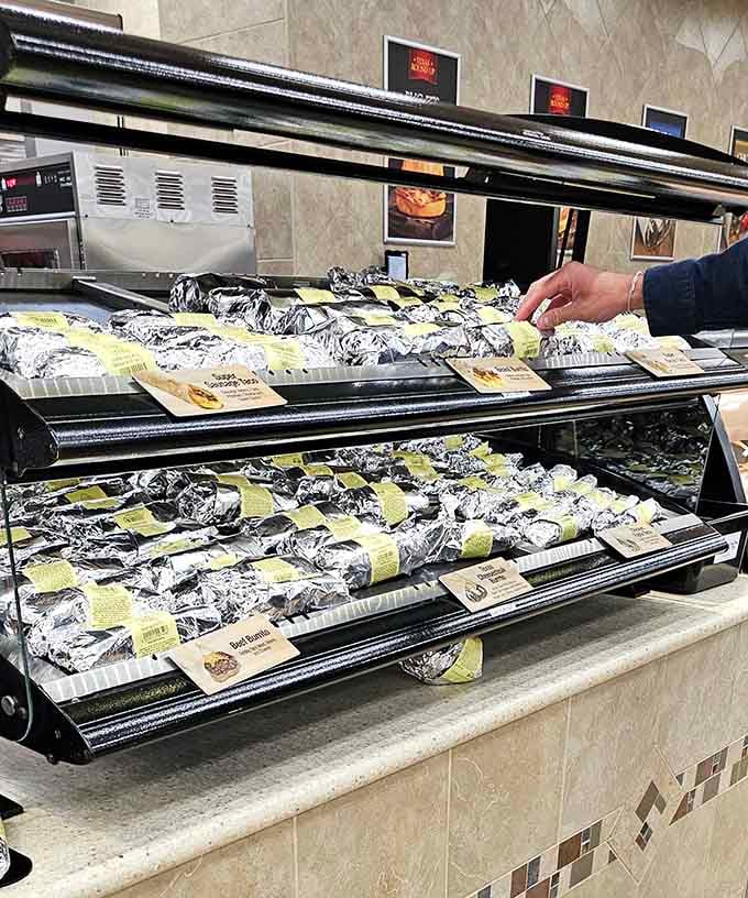 Foil-wrapped brisket sandwiches waiting like delicious presents, ready to redefine your gas station food expectations forever.