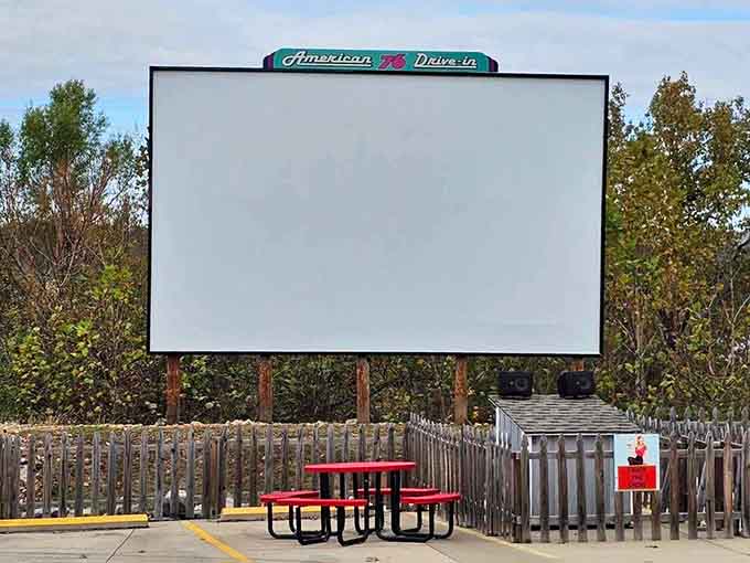 An outdoor movie screen for drive-in vibes, because this place commits fully to the fifties fantasy.