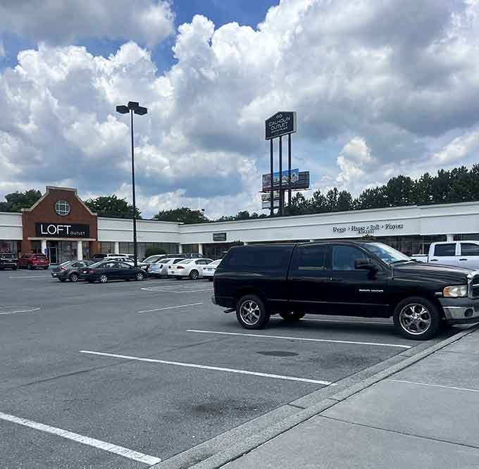 The LOFT Outlet sign towers over cars like a lighthouse guiding bargain hunters safely to their retail destination.