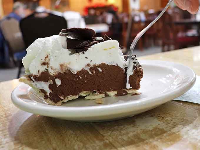 Chocolate cream pie topped with whipped cream and cookie crumbles makes every calorie absolutely worth the investment here.