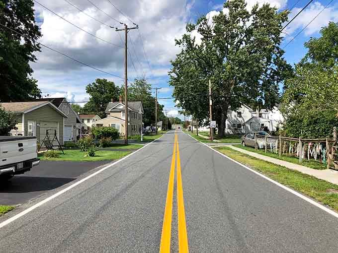 Fresh pavement cuts through residential charm where neighbors still wave and nobody's honking at you for driving the speed limit.