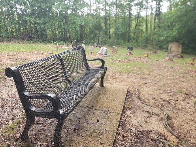 A solitary bench invites quiet reflection among the graves, the perfect spot for remembering your own four-legged best friend.