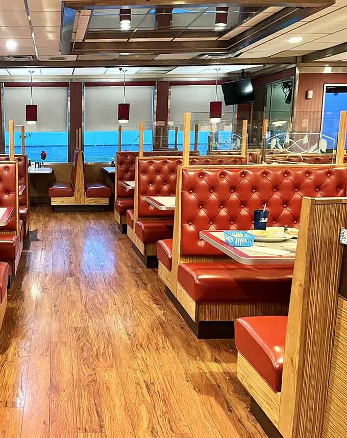 Rich burgundy booths lined up like soldiers, ready to provide comfort and support during your meal.