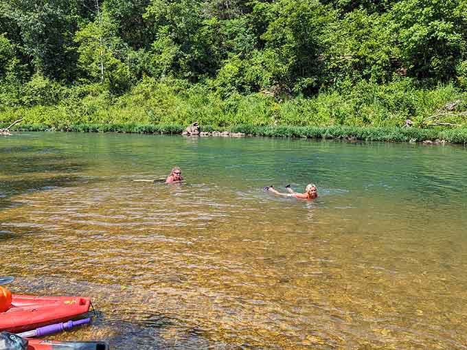 Kids splashing in the shallow, pristine river discover why this place creates lifelong outdoor enthusiasts.