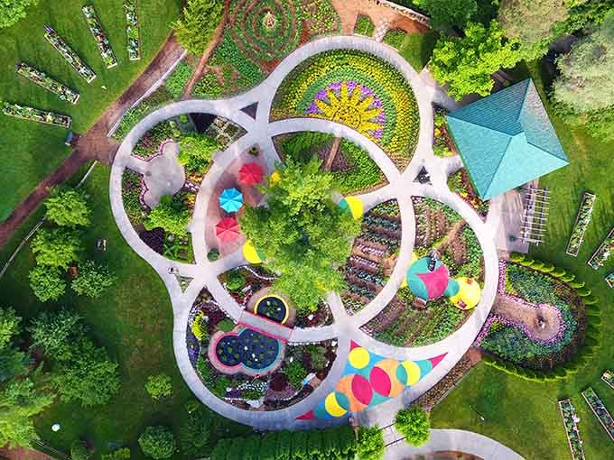 An aerial view reveals the whimsical children's garden design, bursting with colors that delight from every angle.