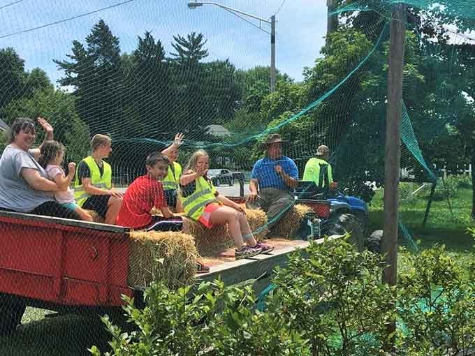 Hayride passengers enjoying the farm tour, proving that simple pleasures never go out of style.