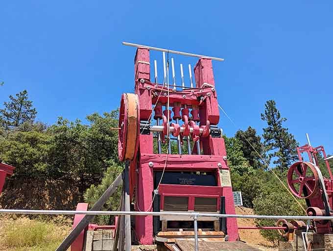 The towering pink stamp mill once crushed ore with thunderous efficiency, turning solid rock into processable powder and profit.