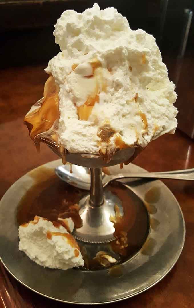 Butterscotch sauce pools around the base like golden treasure that's infinitely more valuable than actual gold.