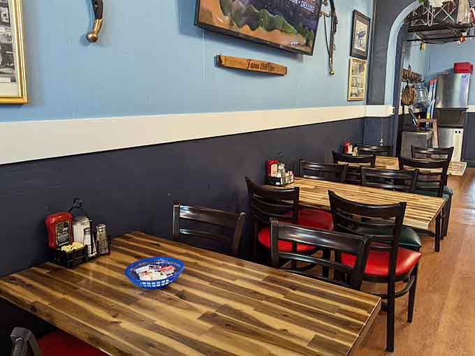 Wooden tables and red accents create that perfect diner atmosphere where everyone feels like a regular customer.
