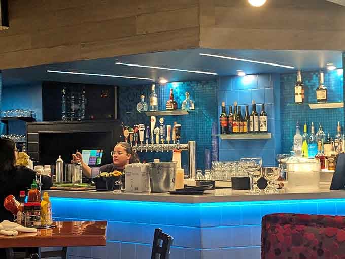 The illuminated bar area provides refreshing beverages to complement your unlimited trips to the grill.