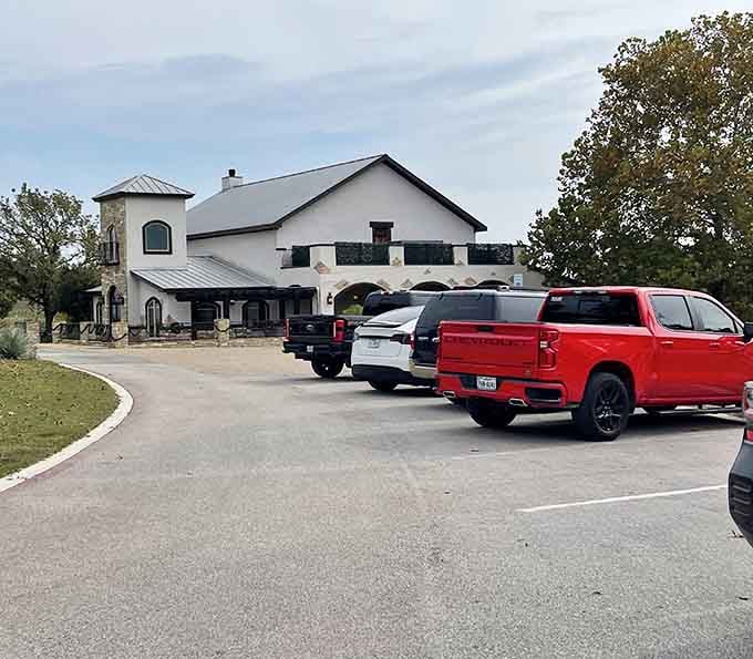 That parking lot full of Texas trucks tells you everything about this winery's local appeal.