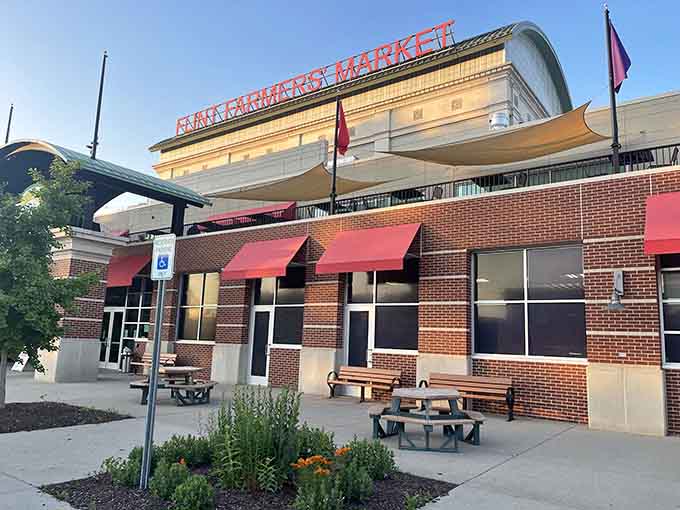 Red awnings and outdoor seating invite you to shop local, support farmers, and taste what fresh really means.