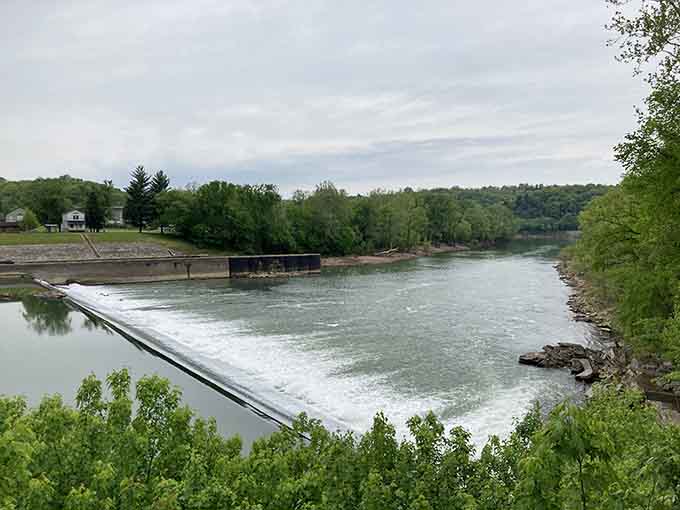 The dam creating peaceful waters that reflect the sky like nature's own mirror on a good day.
