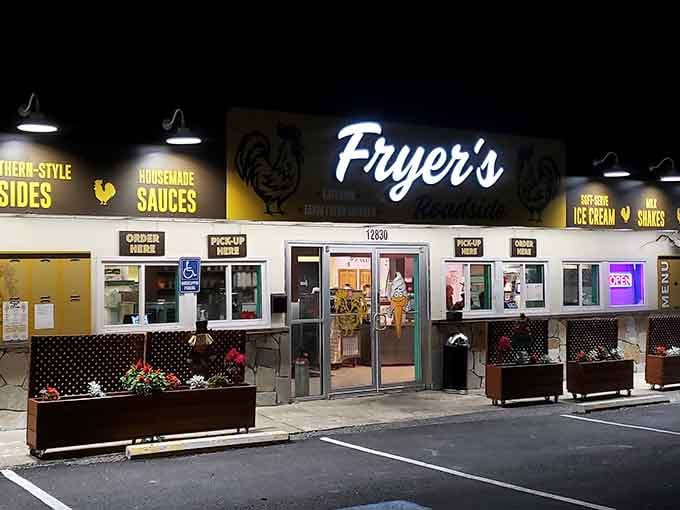 The glowing sign at night beckons like a delicious lighthouse guiding hungry travelers to crispy, golden salvation and happiness.