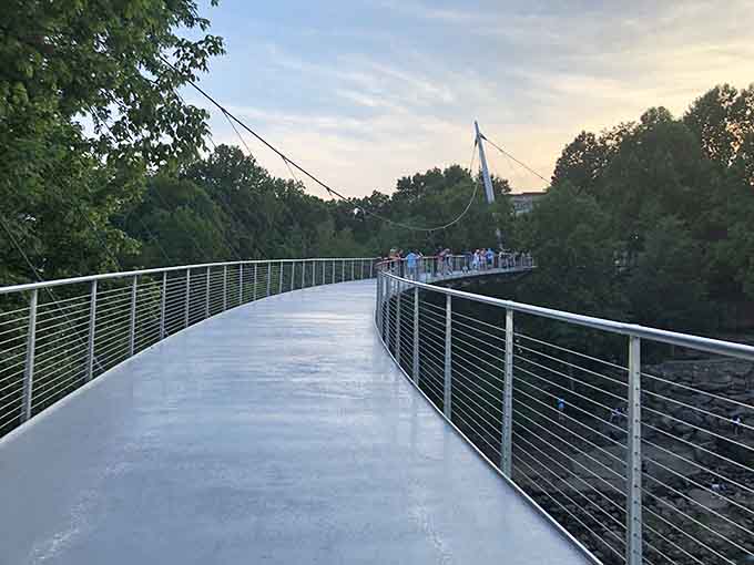 The Liberty Bridge stretches into the evening, offering sunset strollers views that'll fill up your camera roll real quick.