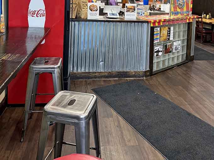 Metal stools and corrugated counter fronts create an industrial vibe that somehow feels perfectly welcoming and unpretentious.