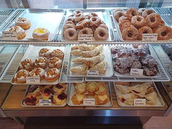 The pastry case displaying apple turnovers, glazed donuts, and cherry treats is basically a museum of deliciousness you can actually eat.