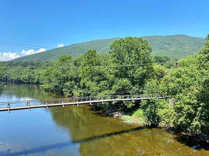 Mountains frame the bridge perfectly, creating a postcard-worthy scene that cameras somehow never quite capture adequately.