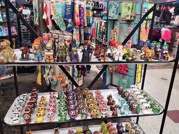 Collectible figurines crowd the glass shelves like a toy convention frozen in time, each one cuter than the last.