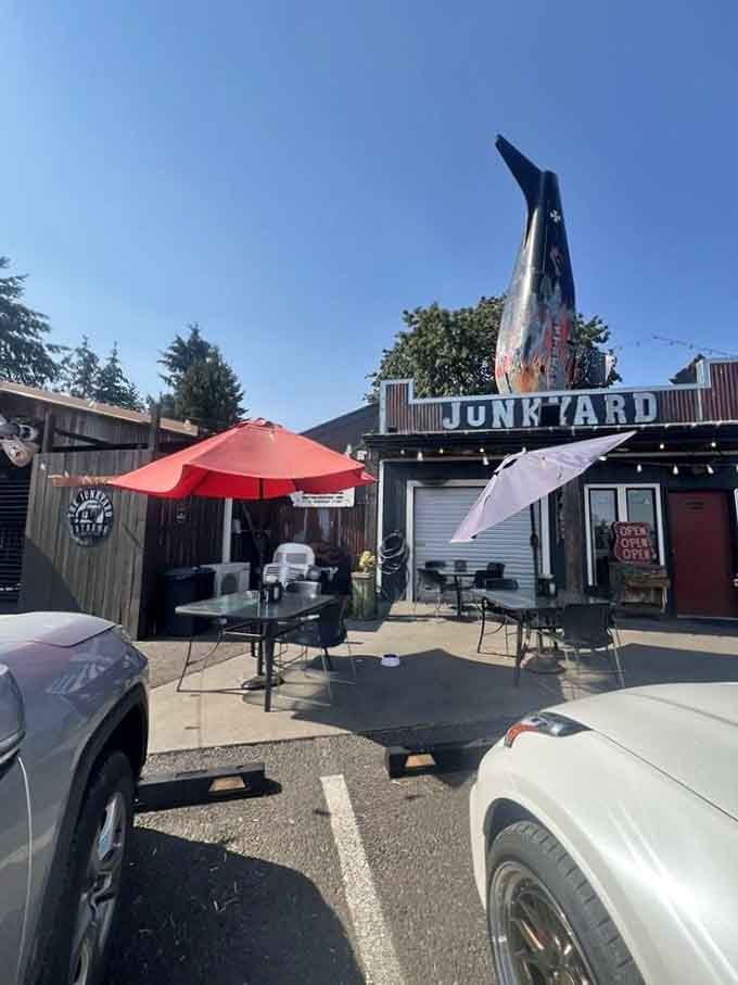 Outdoor seating under red umbrellas and an airplane, because normal patios are overrated and frankly boring.