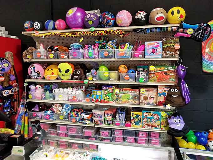 That prize wall overflows with treasures both silly and sublime, where emoji plushies coexist peacefully with classic carnival rewards.