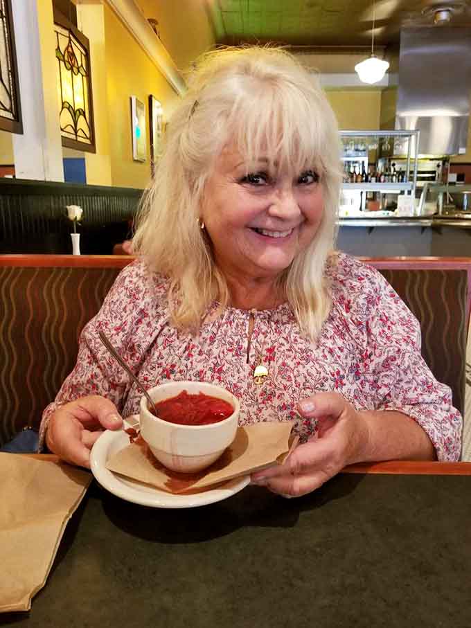 The smile says it all: this borscht just made someone's entire day infinitely better and warmer inside.
