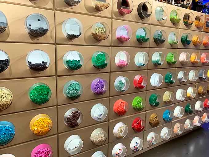 The Pick & Build wall displays every LEGO color imaginable, organized like a rainbow had an organizational intervention.